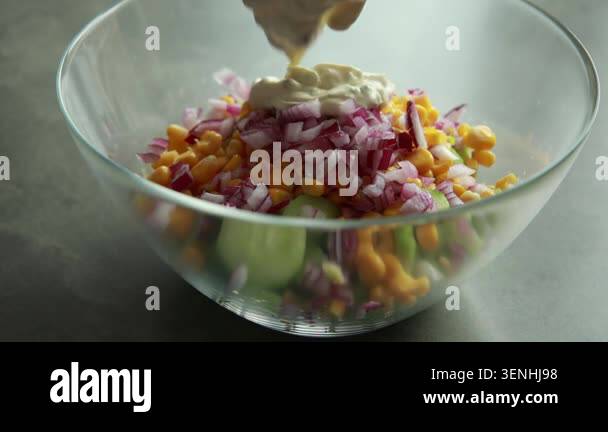 Close-up of a creamy summer salad with sweet corn, crisp cucumber, and ...