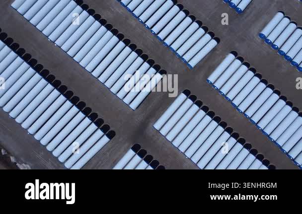 Aerial orbit showcasing rows of white wind turbine towers arranged ...