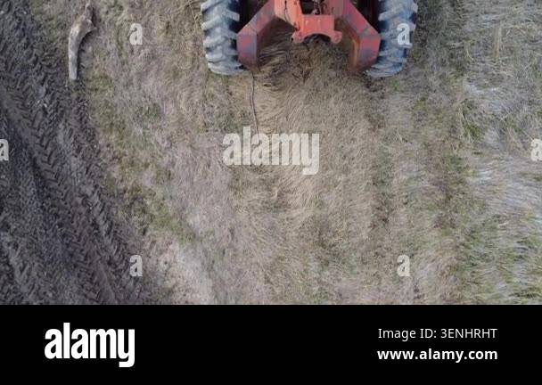 Low-altitude aerial video capturing a rugged vintage Timberjack skidder ...