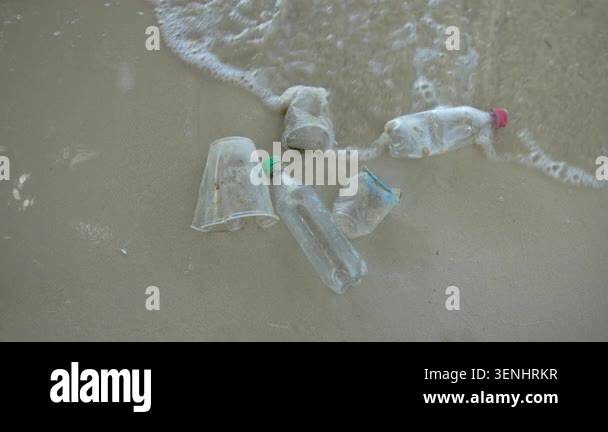 Plastic Bottle Waste Washed Ashore by Ocean Waves, Highlighting Marine ...