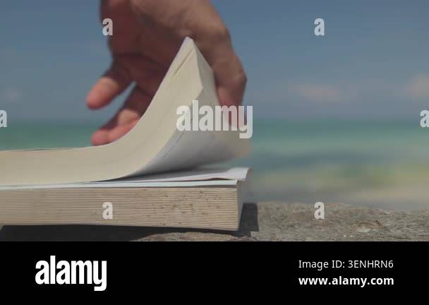 Open Book on Fine Beach Sand in Close-Up View. Open book on the beach ...