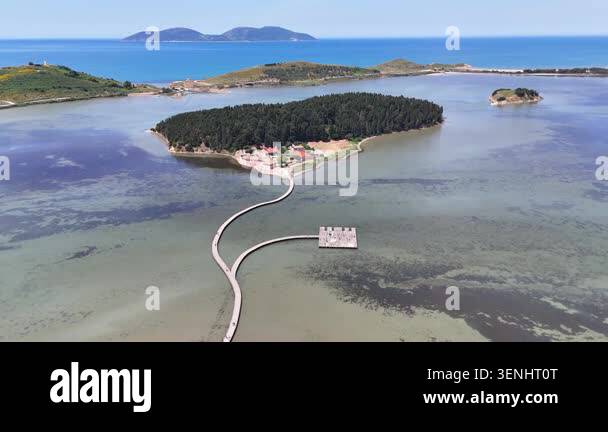 Aerial view of winding wooden walkway leading to a small island with ...