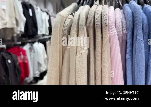 Neutral and Pastel Sweaters Hanging in Contemporary Clothing Store ...