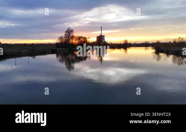 Aerial view of a beautiful sunset over a calm river, showcasing vibrant ...