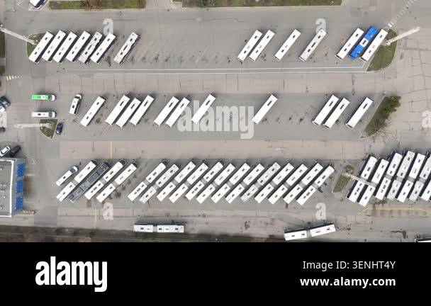 Aerial view of a bus fleet parked in a lot, showcasing a continuous ...