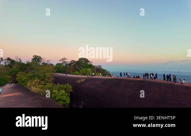 Silhouettes on Massive Coastal Rocks at Sunset Stock Video Footage - Alamy