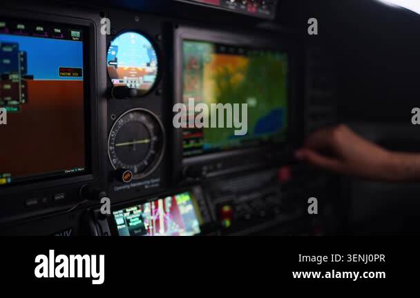 Close up view of a pilots hand navigating on a glass cockpit display ...