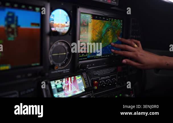 Close up view of a pilots hand interacting with a modern touch screen ...