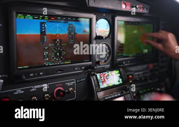 Close up view of an aviators hand using a modern glass cockpit touch ...