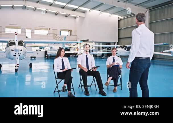 Group of young aviation students listening to their experienced ...