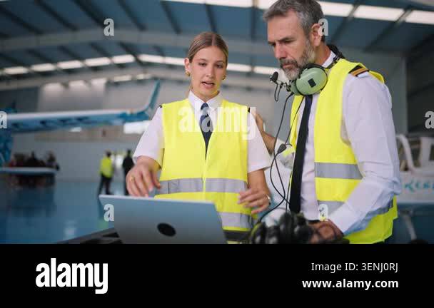 Aviation professionals planning and collaborating on a laptop in an ...