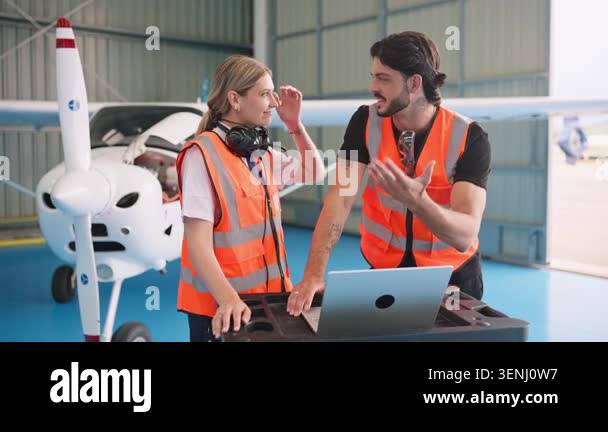 Male and female engineers working together on a laptop, discussing ...