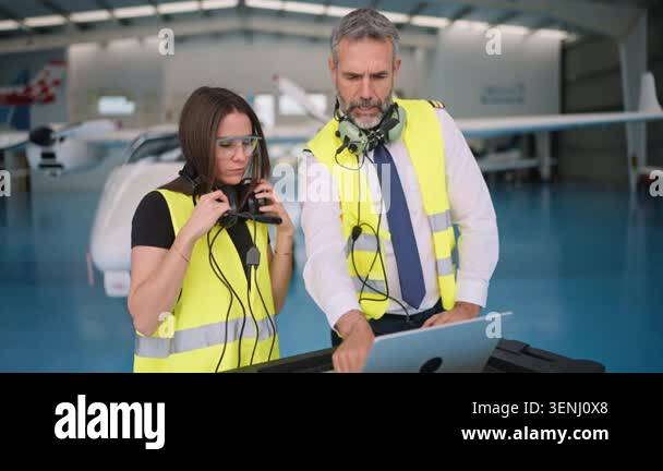 Aviation instructor and female student preparing for a training flight ...