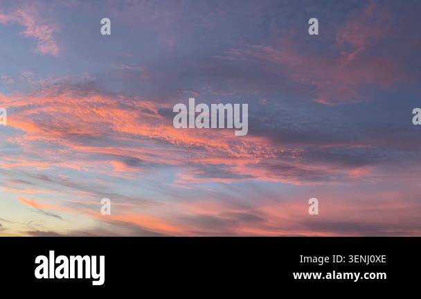 Soft pastel sunset sky with pink clouds and tranquil evening atmosphere ...