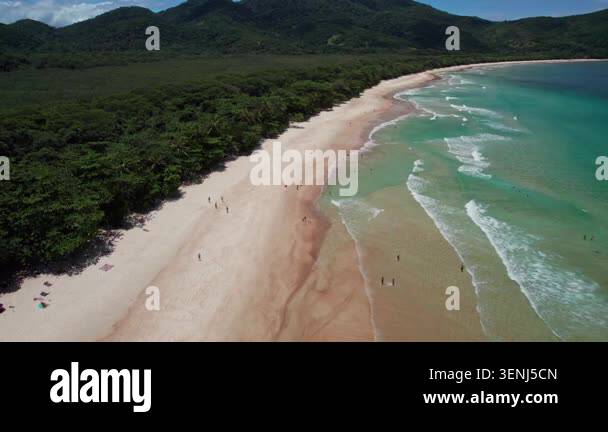 Aerial view of a vibrant tropical beach with clear turquoise waters and ...