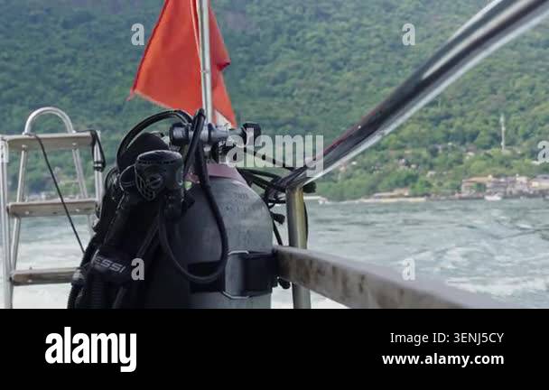 Scuba gear with dive flag on boat, ocean view near Ilha Grande. Prepare ...