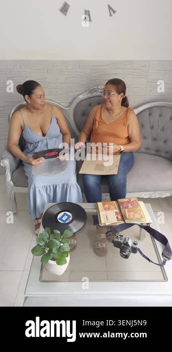 Two women from different generations sharing a nostalgic moment with ...