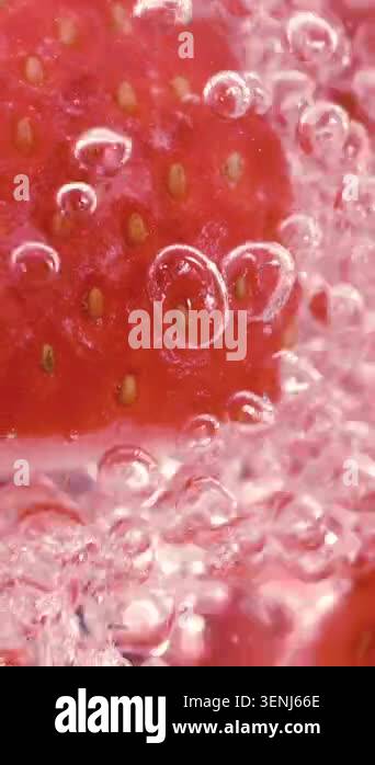 Super Slow Motion Extreme Closeup Strawberry Bubbling In Soda Stock ...