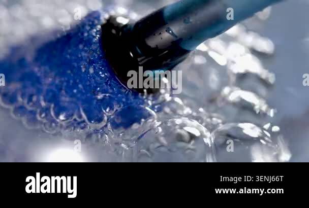 Super Slow Motion Blue Scrub Brush Splashing Water Slowly ...
