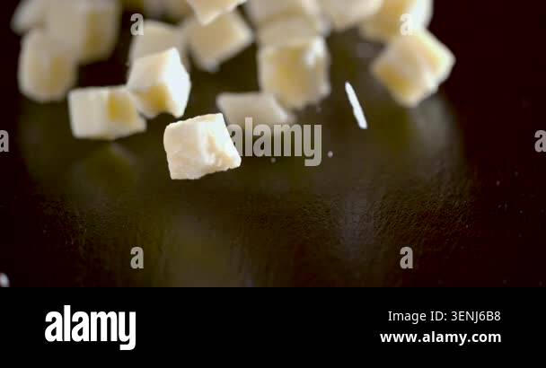 Super Slow Motion Super Slow Motion Scattered Cheese Cubes On Black ...