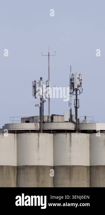 Paired Masts On Concrete Silo Rooftop, Twin Antenna Clusters And ...