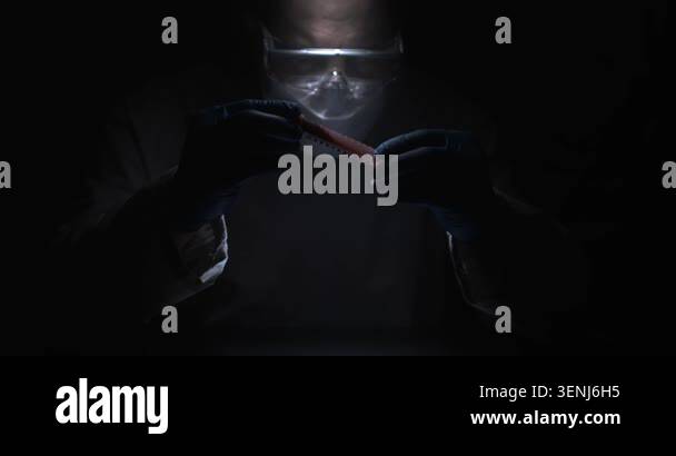 Goggled Analyst Examines Small Evidence Strip With Gloved Hands Under ...