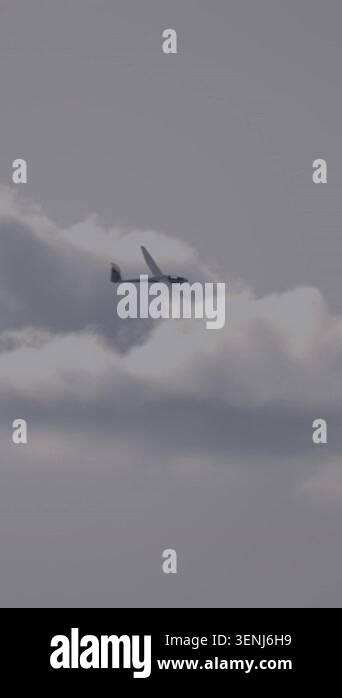 Small Aircraft Soaring Above Heavy Clouds, Distant Silhouette Drifting ...