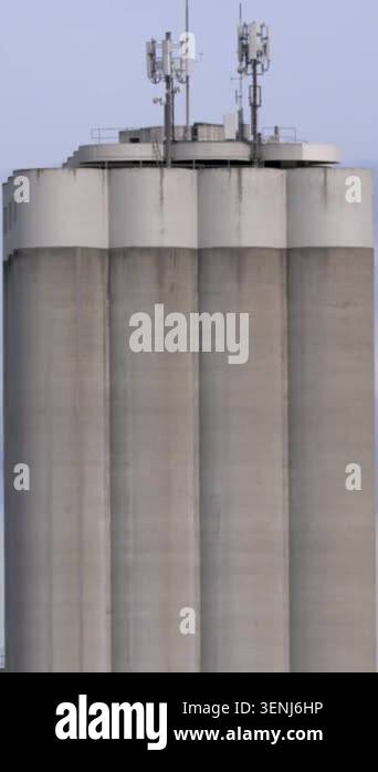 Concrete Grain Silos Topped With Antennas, Closeup Vertical Composition ...