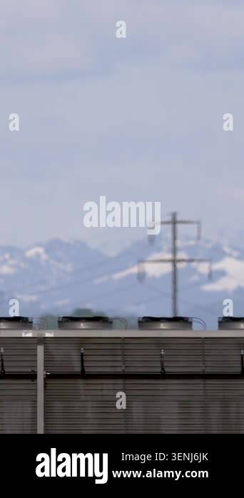 Ventilated Rooftop And Powerline Foreground With Snowcapped Mountains ...
