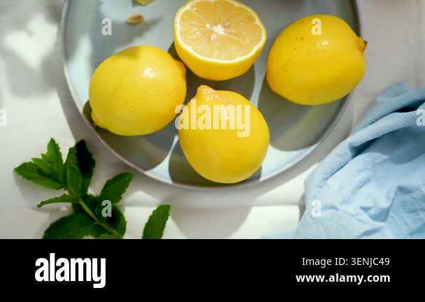 Lemon infused water with mint in glass beside bottle, healthy hydration ...