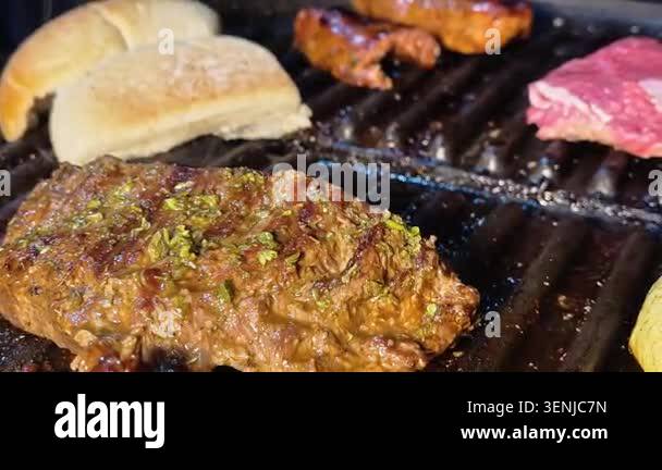 Close up panning shot of juicy grilled steak on hot barbecue with ...