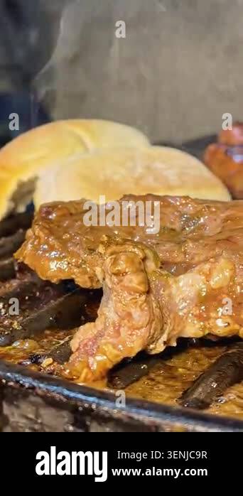 Close up panning shot of juicy grilled steak on hot barbecue with ...