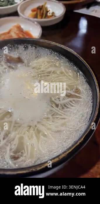 Hot Korean seolleongtang with noodles and beef, steaming on wooden ...