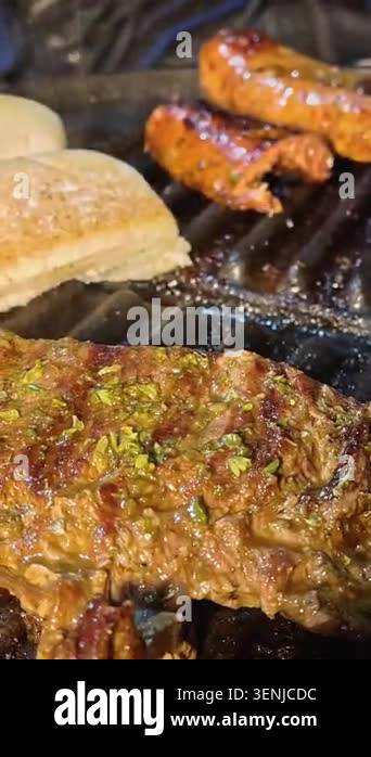 Close up panning shot of juicy grilled steak on hot barbecue with ...