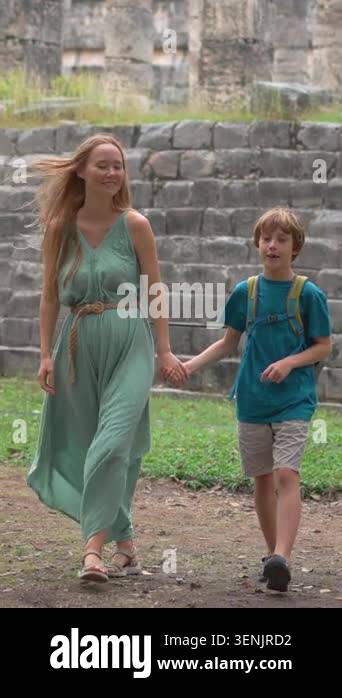 Woman and her 10 year old son walking along the colonnade of the Temple ...