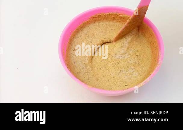 Traditional Ayurvedic Ubtan Powder Mixing Process in Pink Plastic Bowl ...