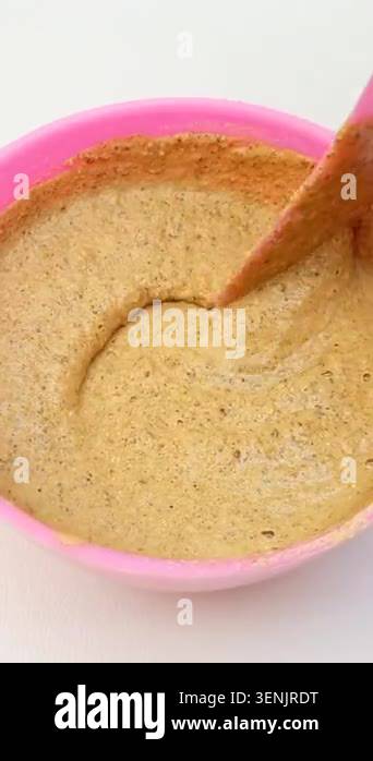 Traditional Ayurvedic Ubtan Powder Mixing Process in Pink Plastic Bowl ...