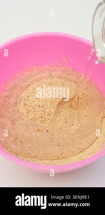 Traditional Ayurvedic Ubtan Powder Mixing Process in Pink Plastic Bowl ...