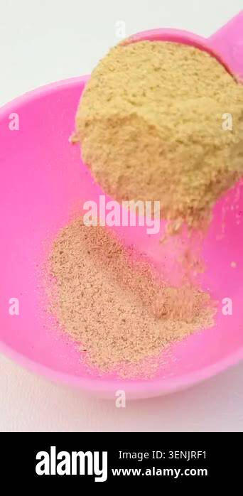 Traditional Ayurvedic Ubtan Powder Mixing Process in Pink Plastic Bowl ...