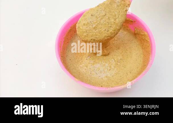 Traditional Ayurvedic Ubtan Powder Mixing Process in Pink Plastic Bowl ...