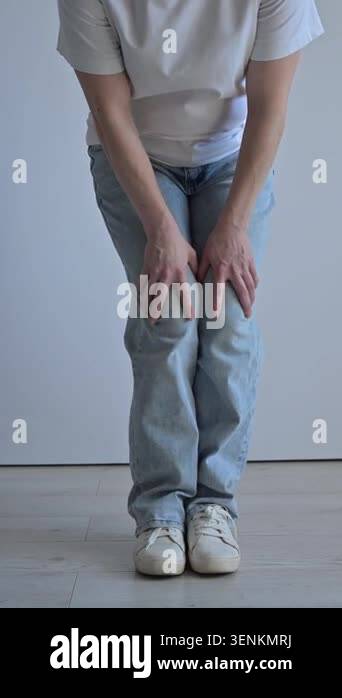 A woman suffers from pain and stretches her knees Stock Video Footage ...