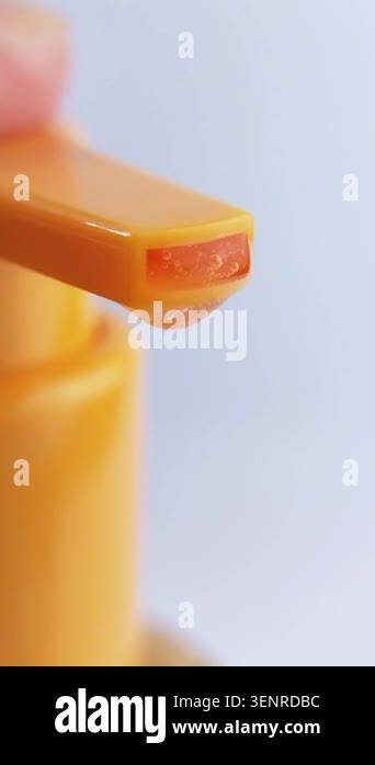 Clear liquid coming out and dripping from orange product packaging ...
