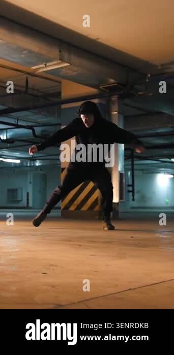 Guy reerunner doing a series of jumps, somersaults and stunts, parkour ...