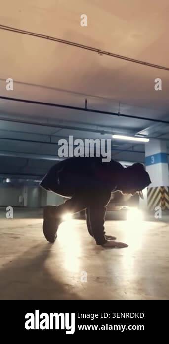 Young stylish man reerunner performing a handstand, parkour acrobatic ...