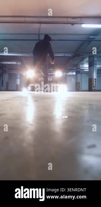 Silhouette of a young stylish man freerunner performing a handstand ...