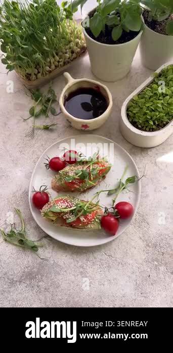Fresh salmon and avocado toast with microgreens, cherry tomatoes, and ...