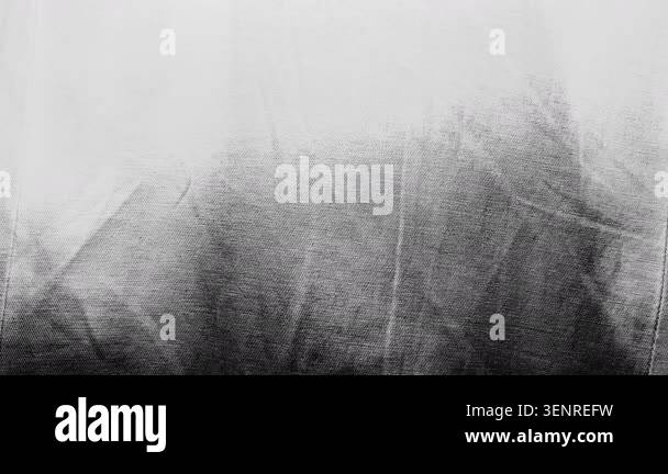 monochrome linen fabric texture ripples gently under dramatic studio ...