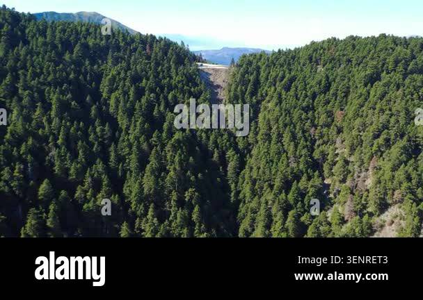 Aerial wide angle view of a deep ravine between mountain slopes covered ...
