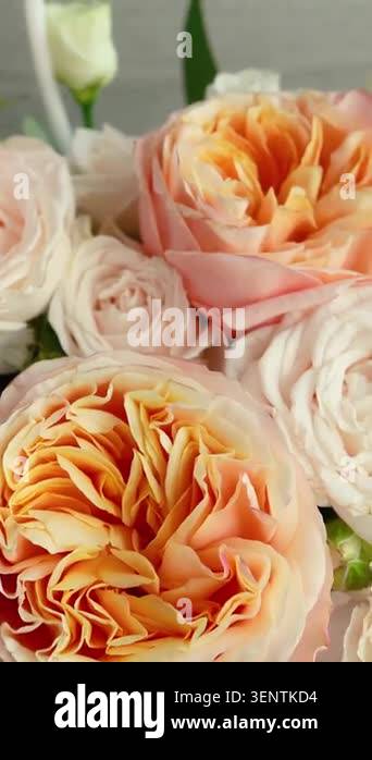 A beautiful romantic bouquet of unusual white roses in a handbag. A ...