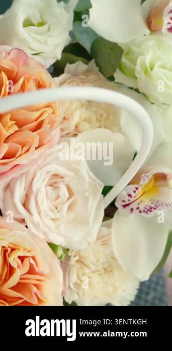 A beautiful romantic bouquet of unusual white roses in a handbag. A ...